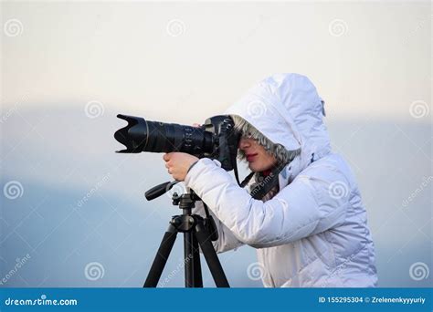 Photographer With Camera And Tripod Outdoor Taking Landscape Picture