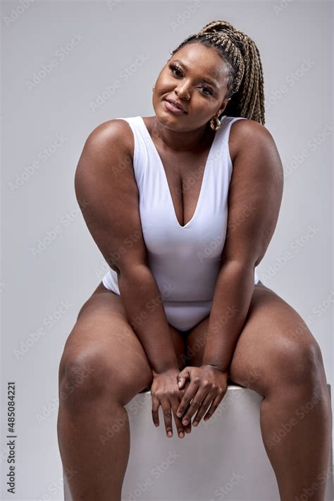 Smiling Young Black American Female In Bodysuit Over White Background