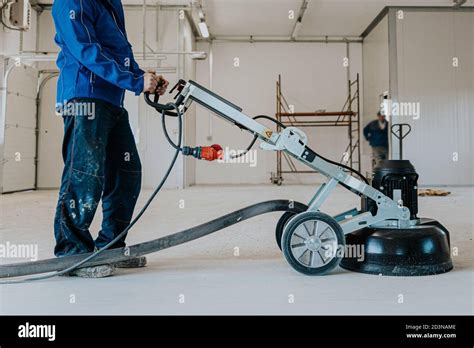 Construction Worker Using Machine Polishing Surface Floor Smoothing And