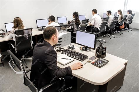 Premium Photo Office Workers At Work On Computers In The Workplace
