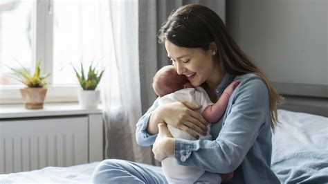Premium Photo Young Attractive Nude Mom Breastfeeding Hugging Her