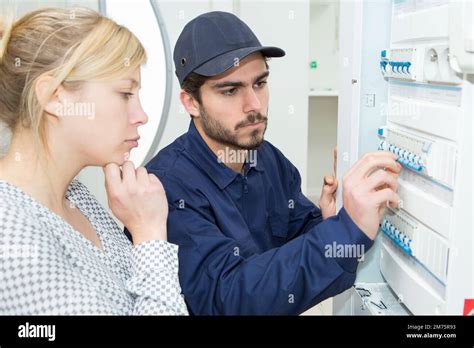 Electrical Man Installing A Fuse Box Stock Photo Alamy