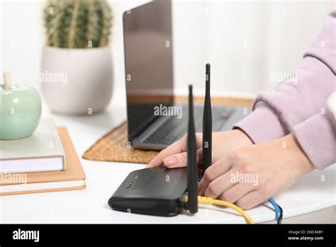 Woman Connecting Cable To Wi Fi Router At Table Indoors Closeup Stock Photo Alamy