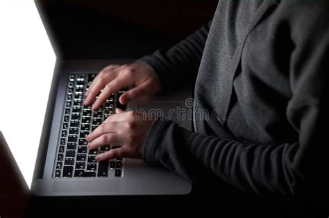 Overhead Hacker In The Hood Working With Laptop Typing Text In The Darkroom Stock Image Image