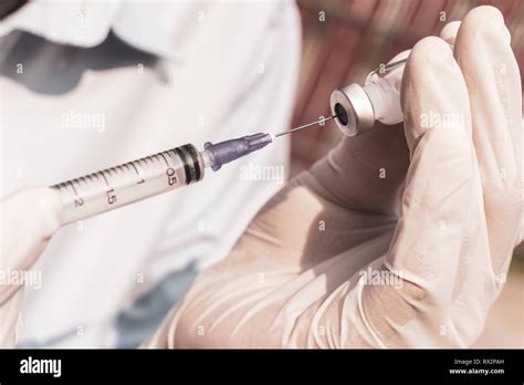 Doctor Hand Holding Vials Medication And Injection Needle Medical
