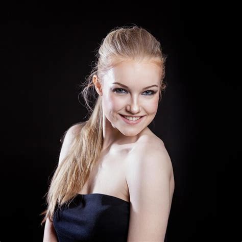 Premium Photo Portrait Of Young Woman Against Black Background
