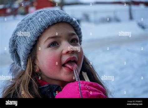Close Up Of Cute Girl Licking Ice During Winter Stock Photo Alamy