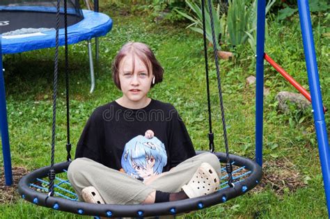 Teenage Girl Sits On A Swing Spider Web In The Garden Clothes Depict A