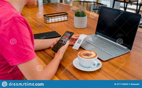 Woman Using Contactless Payment By Mobile Phone With Qr Code At Cafe