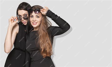 Premium Photo Two Young Happy Fashion Women In Black Dresses