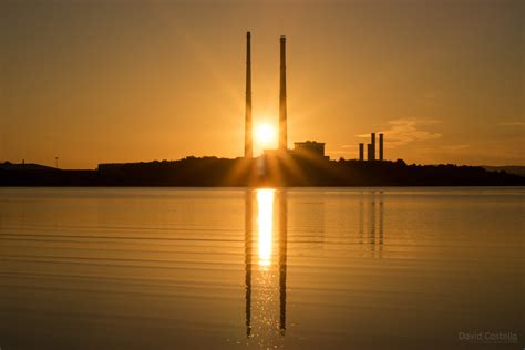 Sunrise Between The Poolbeg Chimneys Print By David Costello