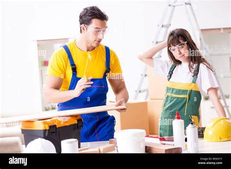 Man Explaining Woman Woodworking Tips In Wood Workshop Stock Photo Alamy
