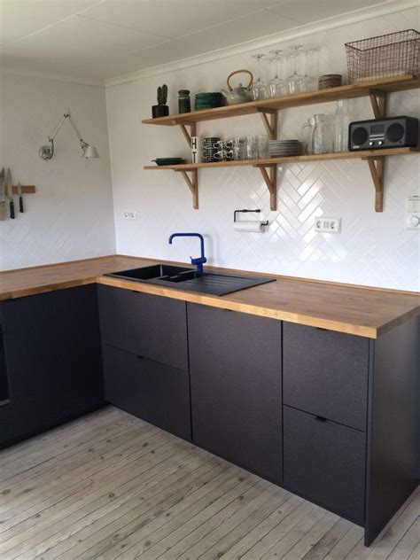 Matte Black Cabinets With Wooden Countertops Are A Bold And Modern Idea