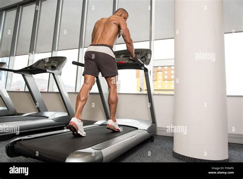 Handsome Man Running On The Treadmill In Gym Stock Photo Alamy