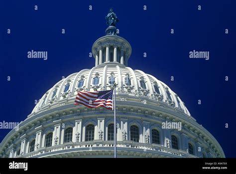 Capitol Building Dome Rippling United States Flag Flying On Flagpole