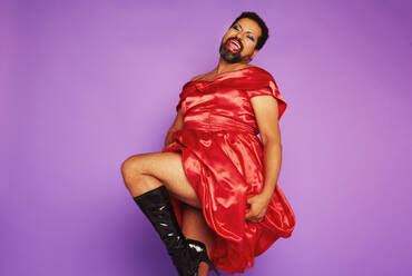 Full Length Of Gay Man Wearing Women Clothing Dancing And Performing In Studio Androgynous Male