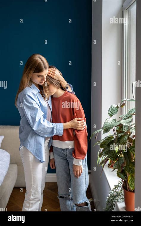Loving Older Sister Embracing Upset Crying Teen Girl Mother Hugging