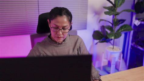 Close Up Of Woman Building Software And Coding Looking At Large Computer Screen Displaying