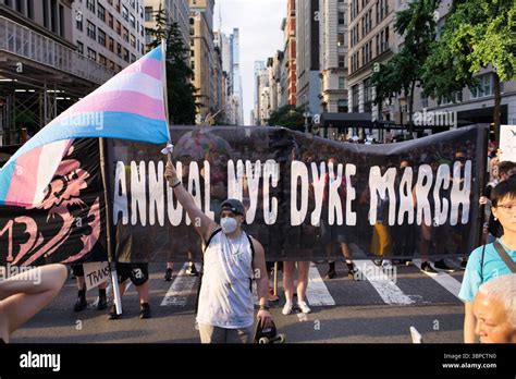 A Person Holds A Transgender Flag At The Annual Nyc Dyke March A Large