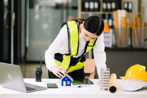 Premium Photo Creative Architect Projecting On The Big Drawings Working And Laptop With On On