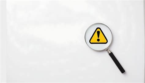 premium photo warning sign inside of magnifier glass for notification