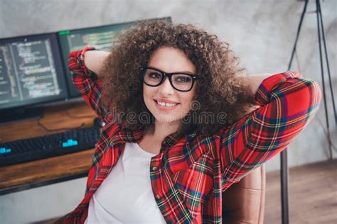 Smiling Young Professional Programmer Relaxing In Modern Workspace With