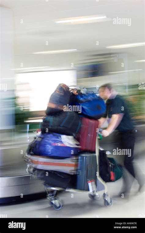 Man Pushing Baggage Trolley Stock Photo Alamy