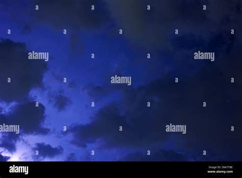 The Clouds Move Fast Across The Dark Night Sky The Flashes Of Light From The Approaching Storm