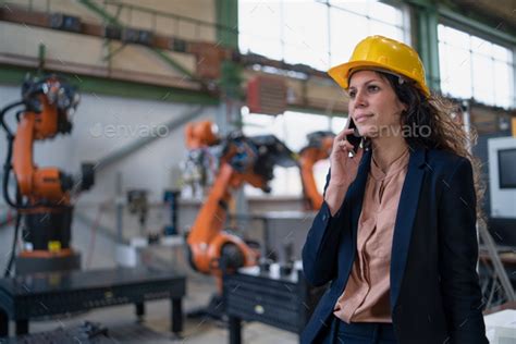 automation female engineer with tablet for programming robotic arm