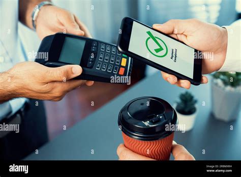 Hand Holding Smartphone With NFC QR Code Device Scanning Contactless Payment Code For Fast
