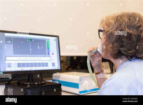 A Middle Aged Woman Undergoing A Spirometry Test In A Pneumology