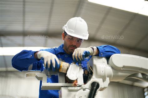 robotics engineer operating robot aided cnc machine in robotics