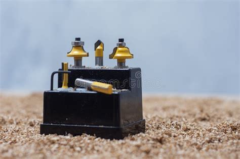 Yellow Bits For Router Saw On A Sawdust Covered Surface Tools For