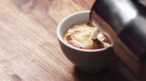 Slow Motion Closeup Pour Steamed Milk Into Coffee With Big Bubbles