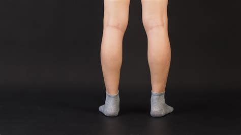 Premium Photo Male Legs Wear Grey Sock Is Isolated On Black Background
