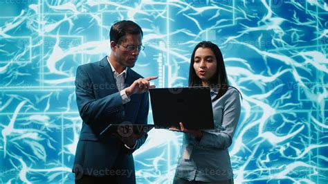 It Department Colleagues Solving Tasks On Laptop And Tablet Running Artificial Intelligence
