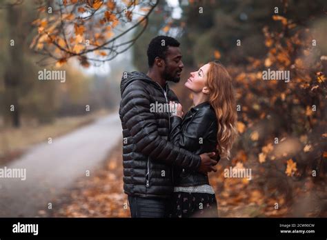 Happy Cute Interracial Couple Posing In Blurry Autumn Park Background