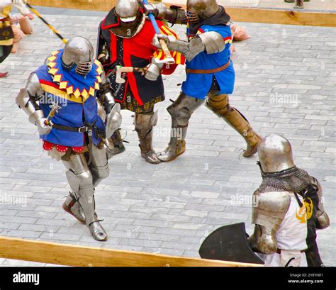 Reenactment Of Medieval Knights In Armour Fighting In Traditional