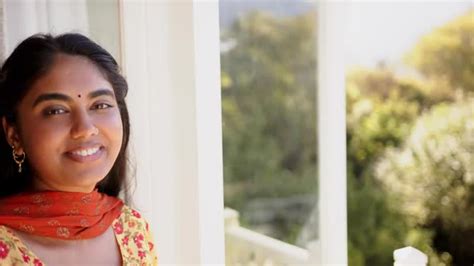 Smiling Indian Woman In Traditional Indian Sari Standing By Window