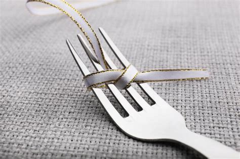 Premium Photo Stages Of Tying Bow On Fork Closeup