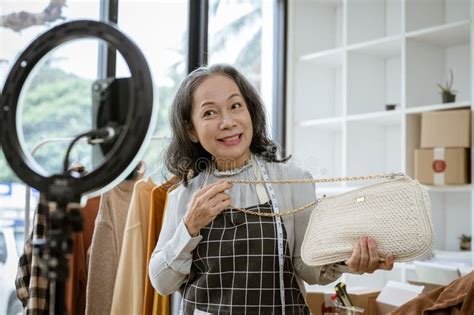 A Mature Asian Female Online Seller Is Live Streaming From Home