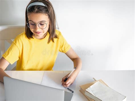 A Teenage Girl Does Her Homework While Sitting With Books And A Laptop Stock Image Image Of