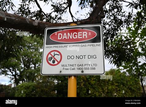 Rectangular Multinet Gas Network Danger Sign Attached To A Yellow Pole