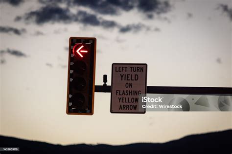 Closeup Shot Of A Traffic Light And Sign Indicating Left Turn Yield On