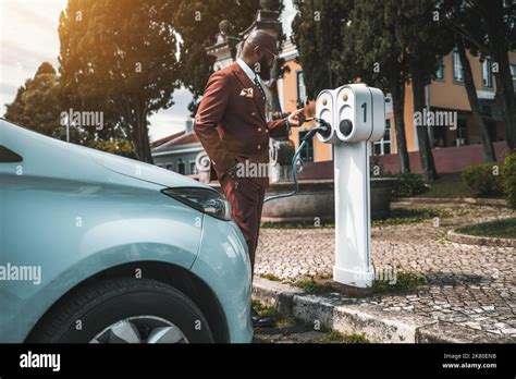 Side View Of A Dapper Bald Bearded Black Man In An Elegant Tailored Chestnut Color Costume