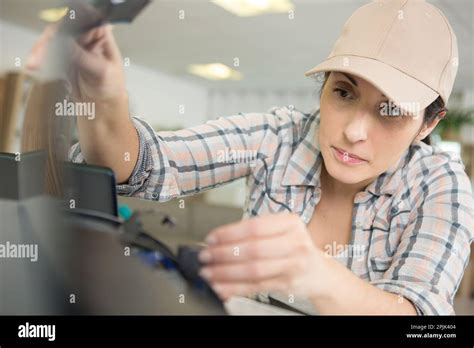 Mature Woman Fixing A Printer Stock Photo Alamy