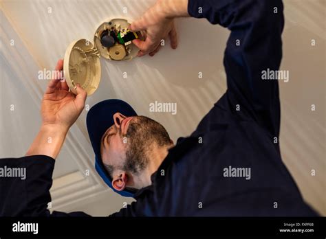 Handyman Installing Smoke Detector Stock Photo Alamy