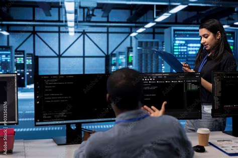 Engineer In Server Farm Checking Recovery Plan Monitoring Data Center
