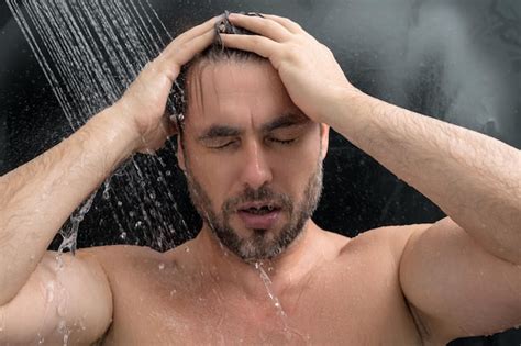 Premium Photo Man Taking A Shower Washing Hair With Shampoo Under Water Falling From Shower