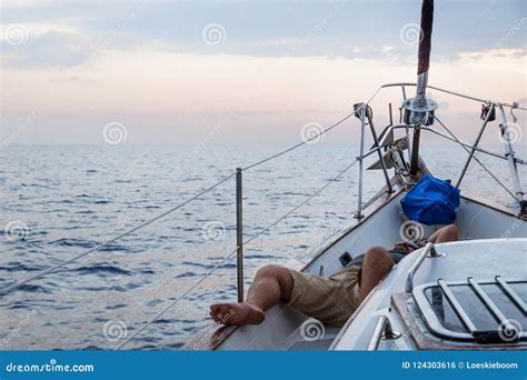 Man Sleeping At The Front Of Sailboat After Sunset In Honduras Central